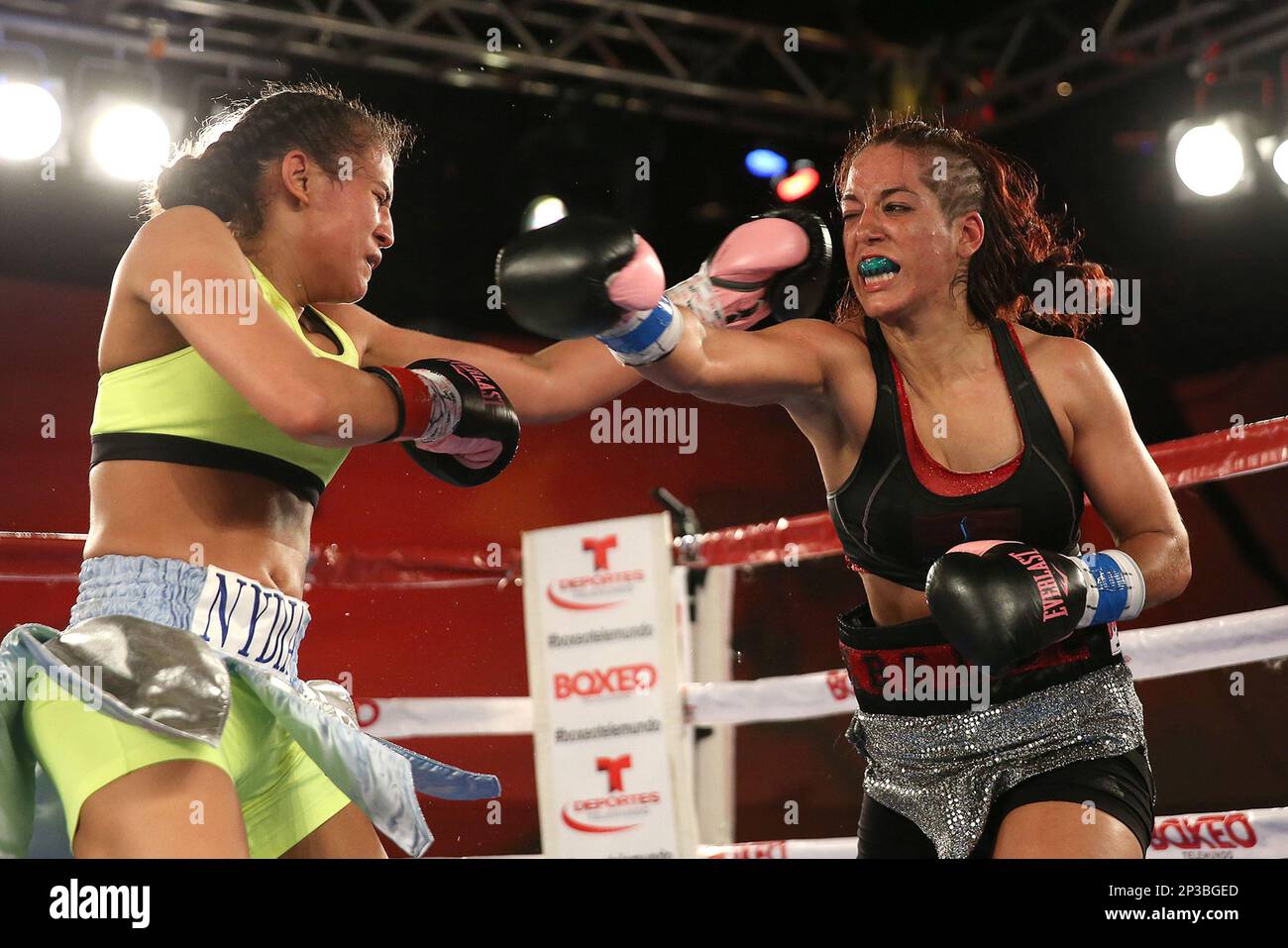 Noemi Bosques (R) throws a right hand against Nydia Feliciano during a ...