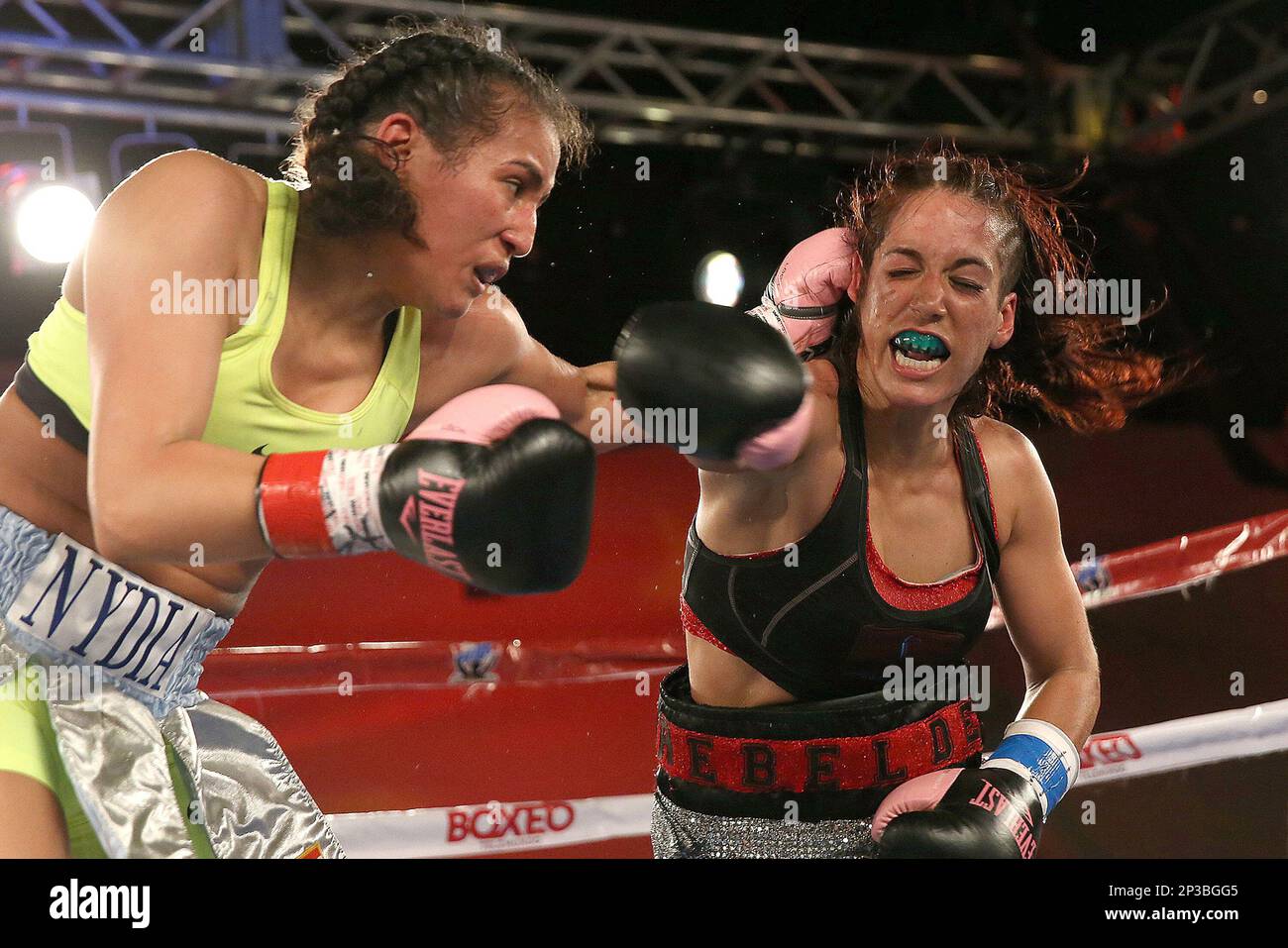 Noemi Bosques (R) throws a right hand against Nydia Feliciano"s left ...