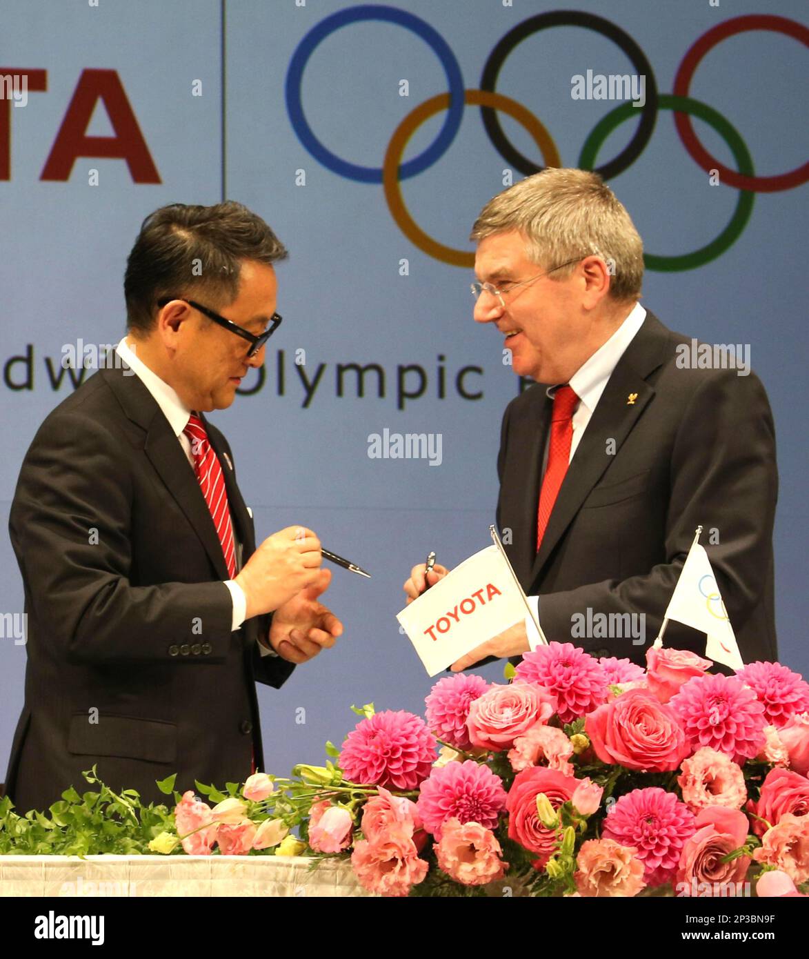 Akio Toyoda (L), President of Toyota Motor Corp. and Thomas Bach ...