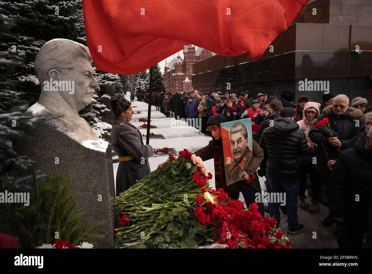 Communist party supporters with red flags and a portrait of Josef ...