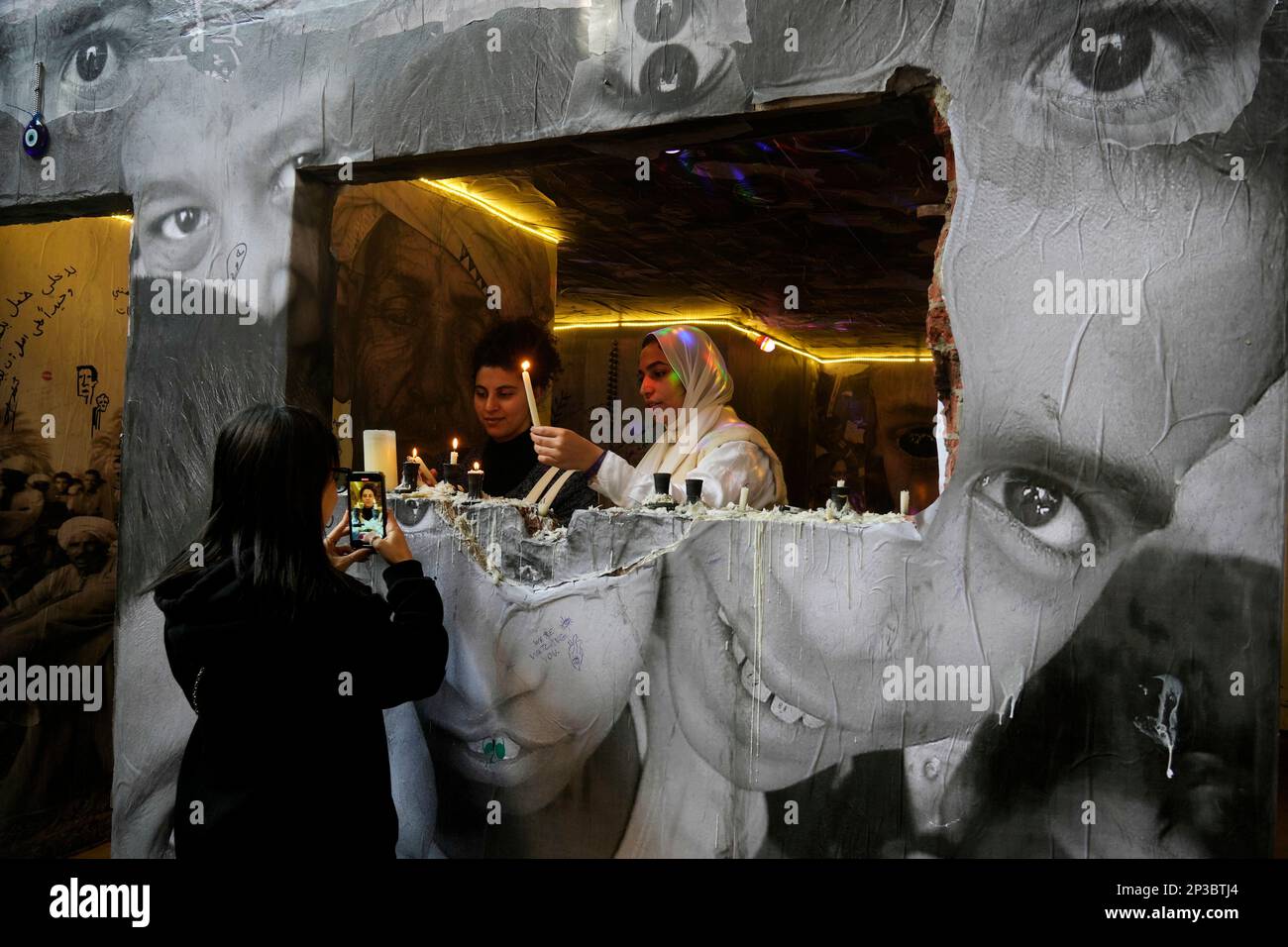 Visitors light candles at the art work "Communications" of Egyptian ...