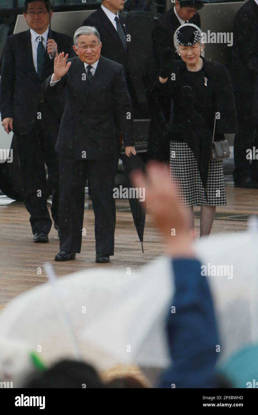 Japan's Emperor Akihito and Empress Michiko wave their hands to people ...