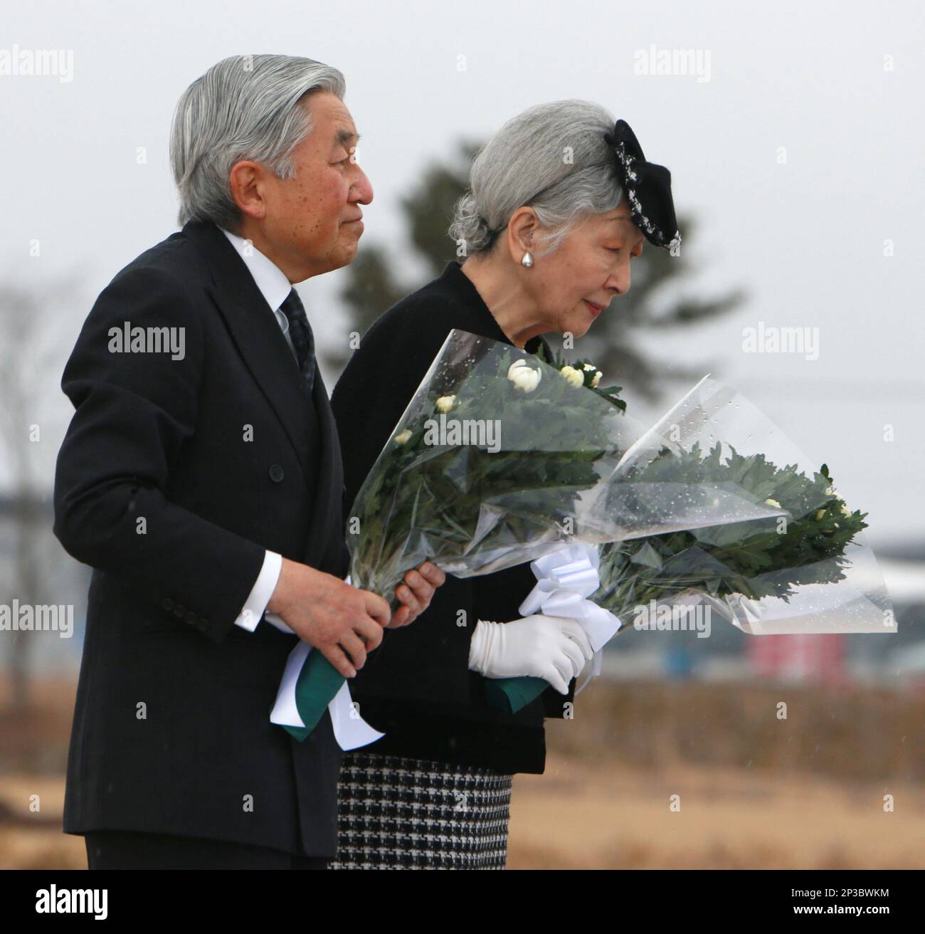 Japan's Emperor Akihito and Empress Michiko offer flowers at the ...