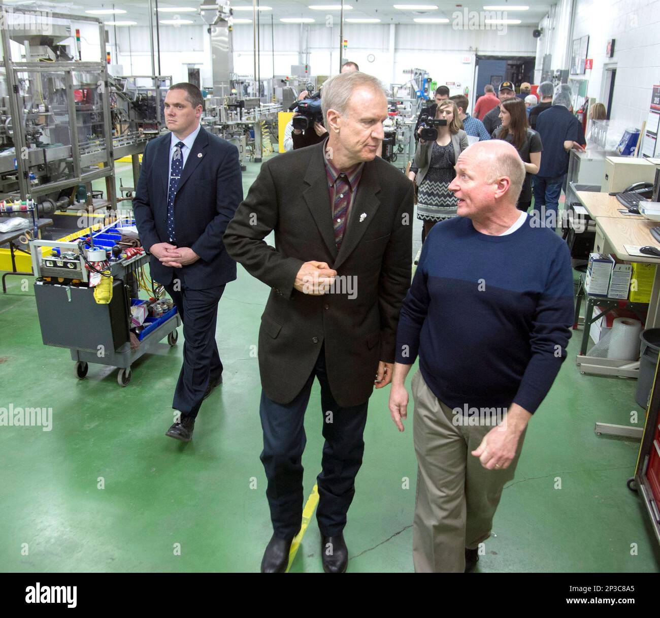 Illinois Gov. Bruce Rauner, left, walks with Combe Laboratories vice ...