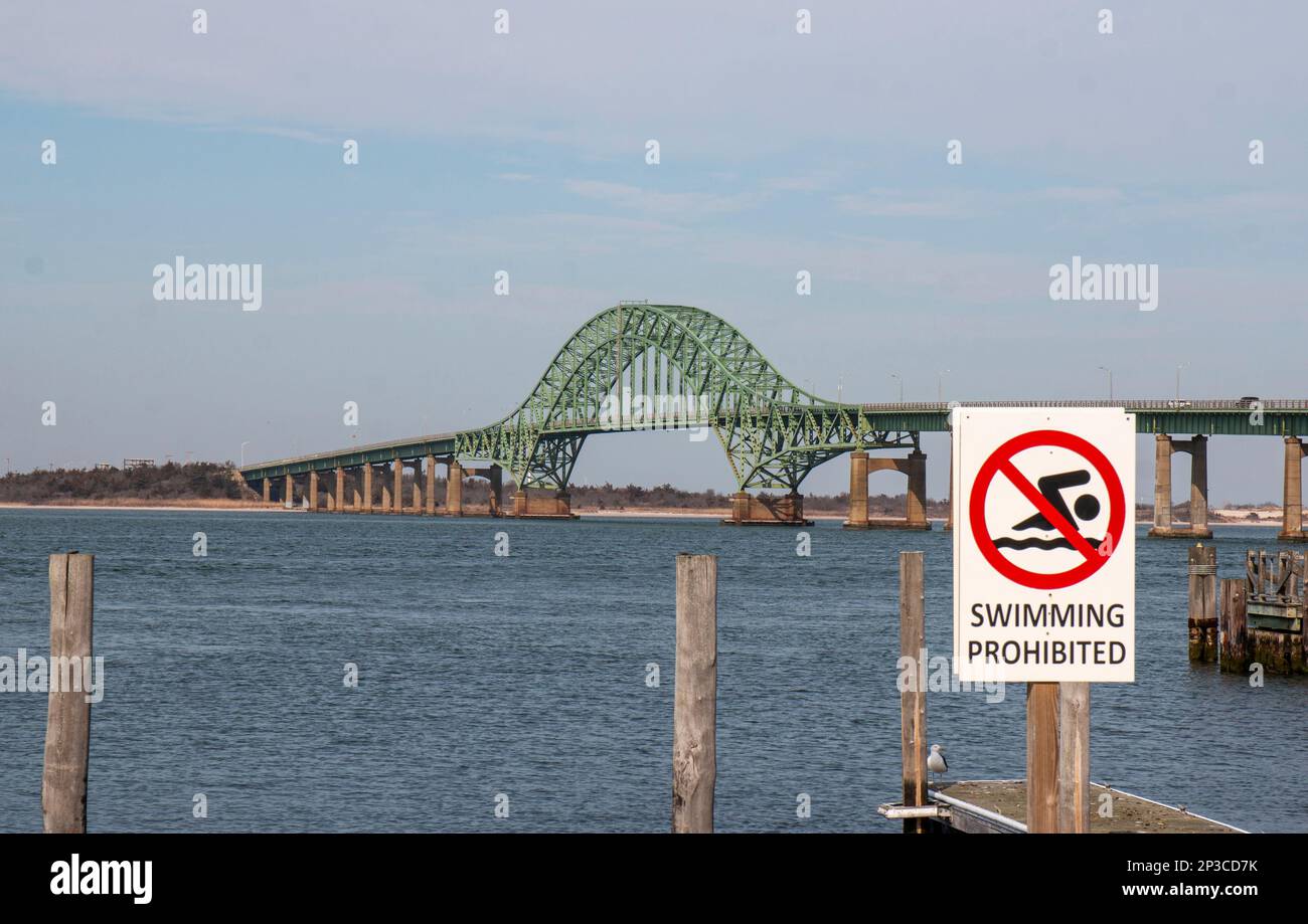 Swimming prohibited sign with the Robert Moses Bridge in the background ...