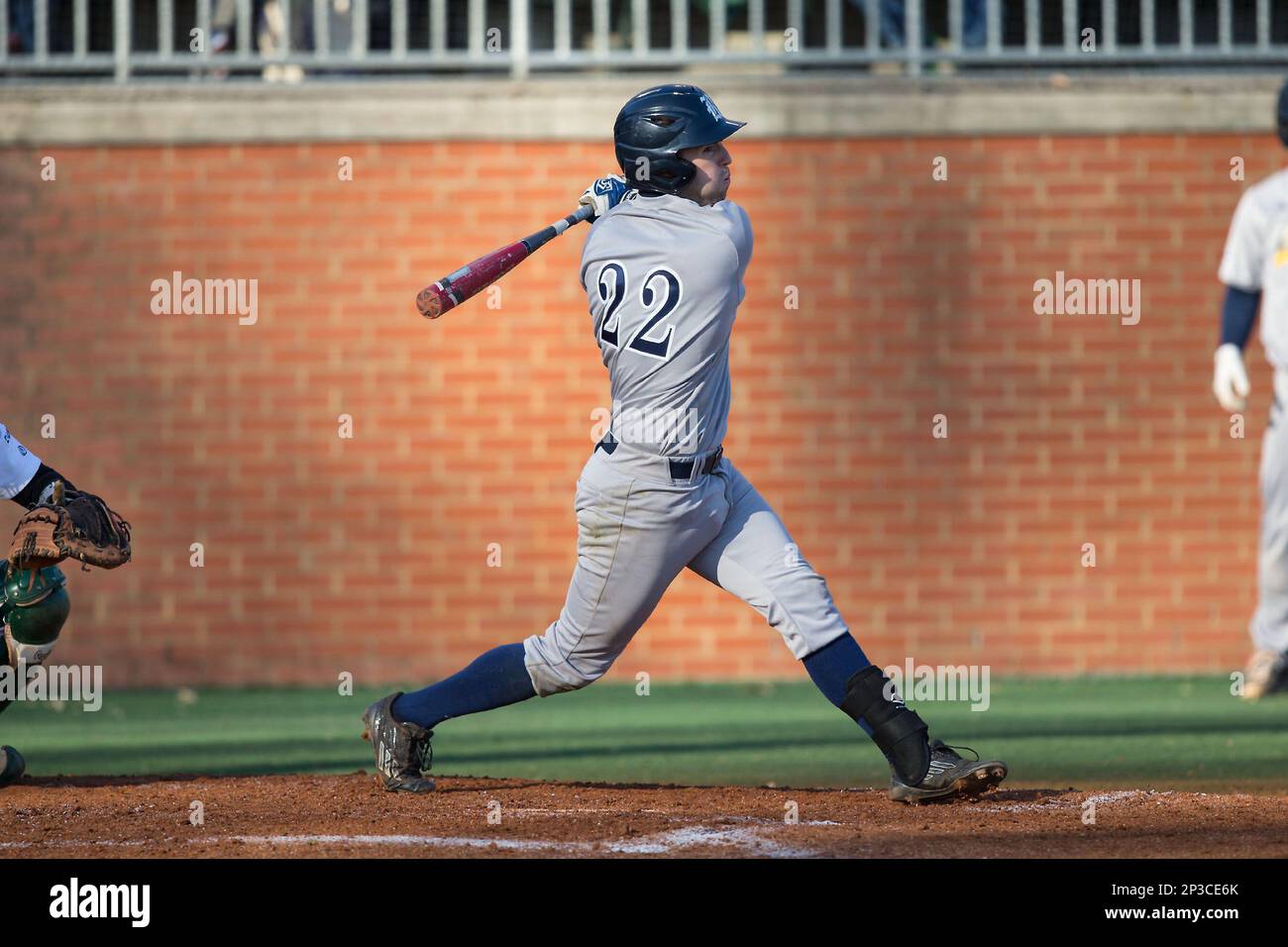 Grayson Lewis (22) of the Rice Owls follows through on his swing ...