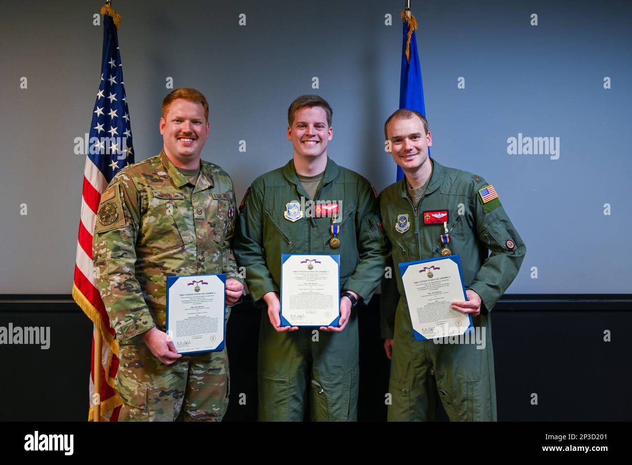 U.S. Airmen gather for a group photo holding their Air Medal citations ...