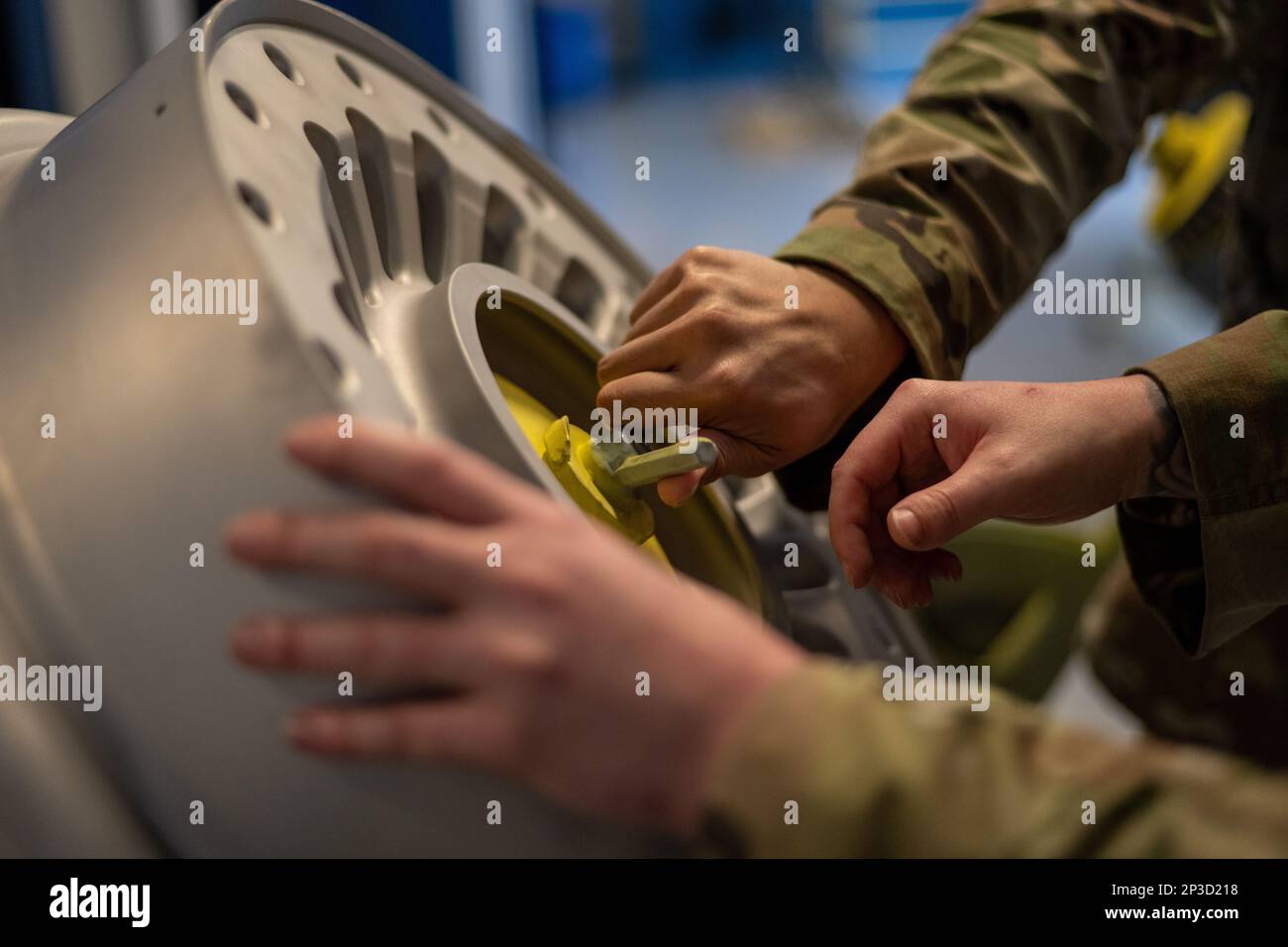 U.S. Airmen assigned to the 6th Maintenance Squadron clamp a wheel to a ...