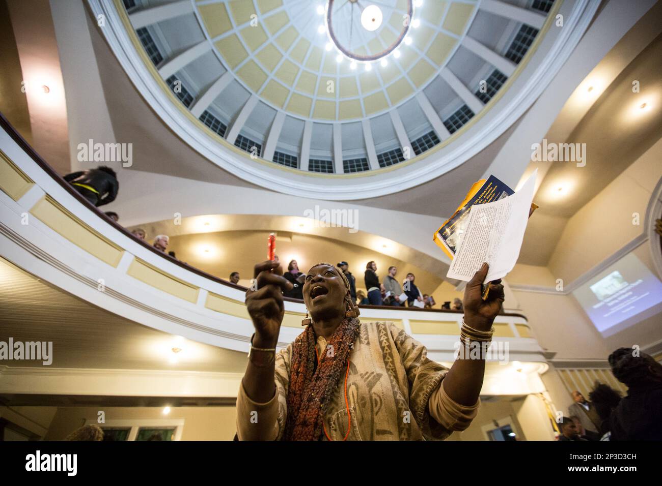 Yomi Goodall calls for those in attendance to sign a petition to ...