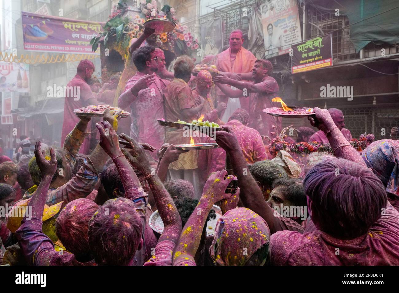 Hindu devotees with offerings make their way to reach a car carrying an ...