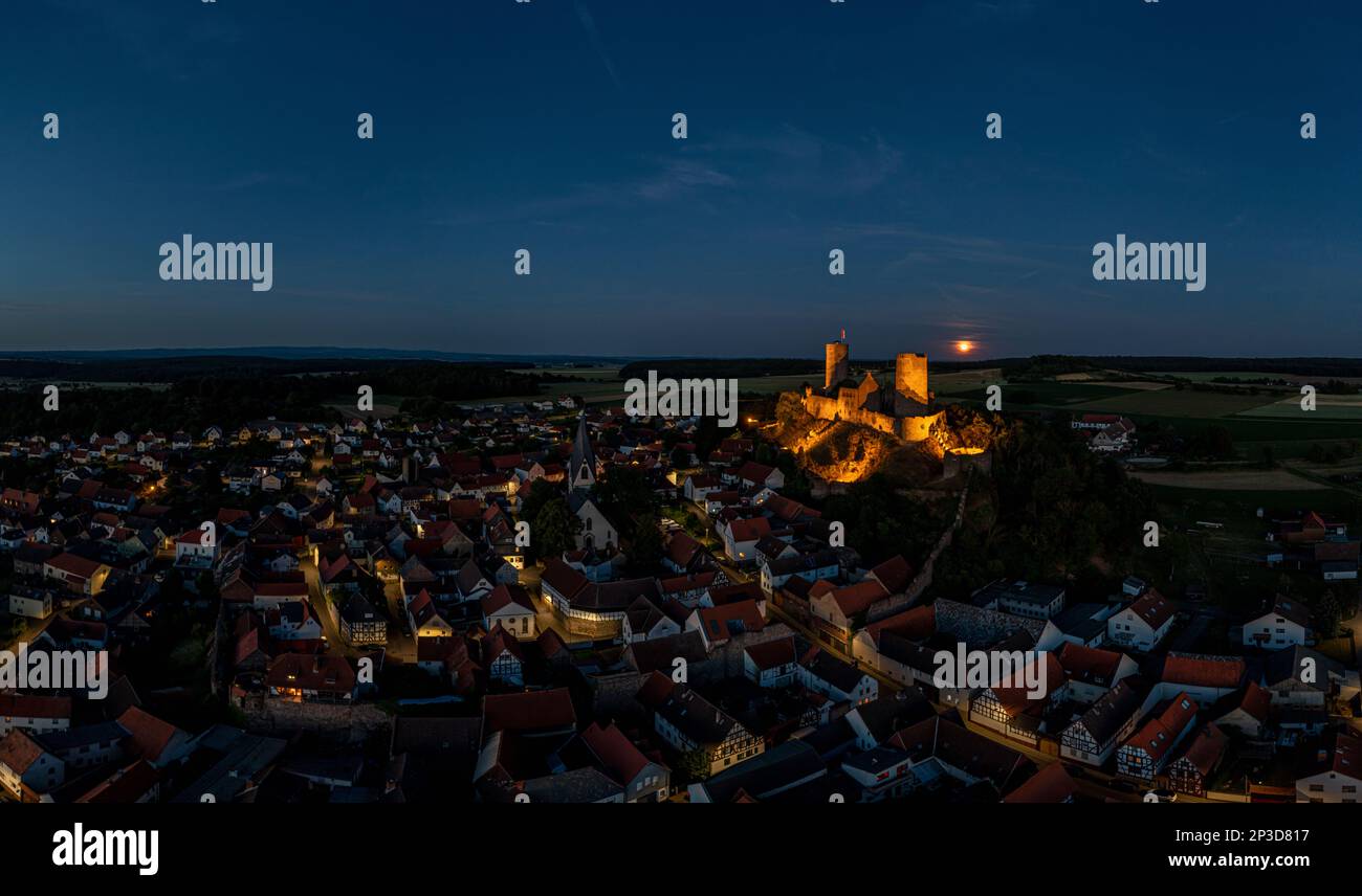 Image of illuminated Muenzenberg castle ruins in Germany in the evening ...