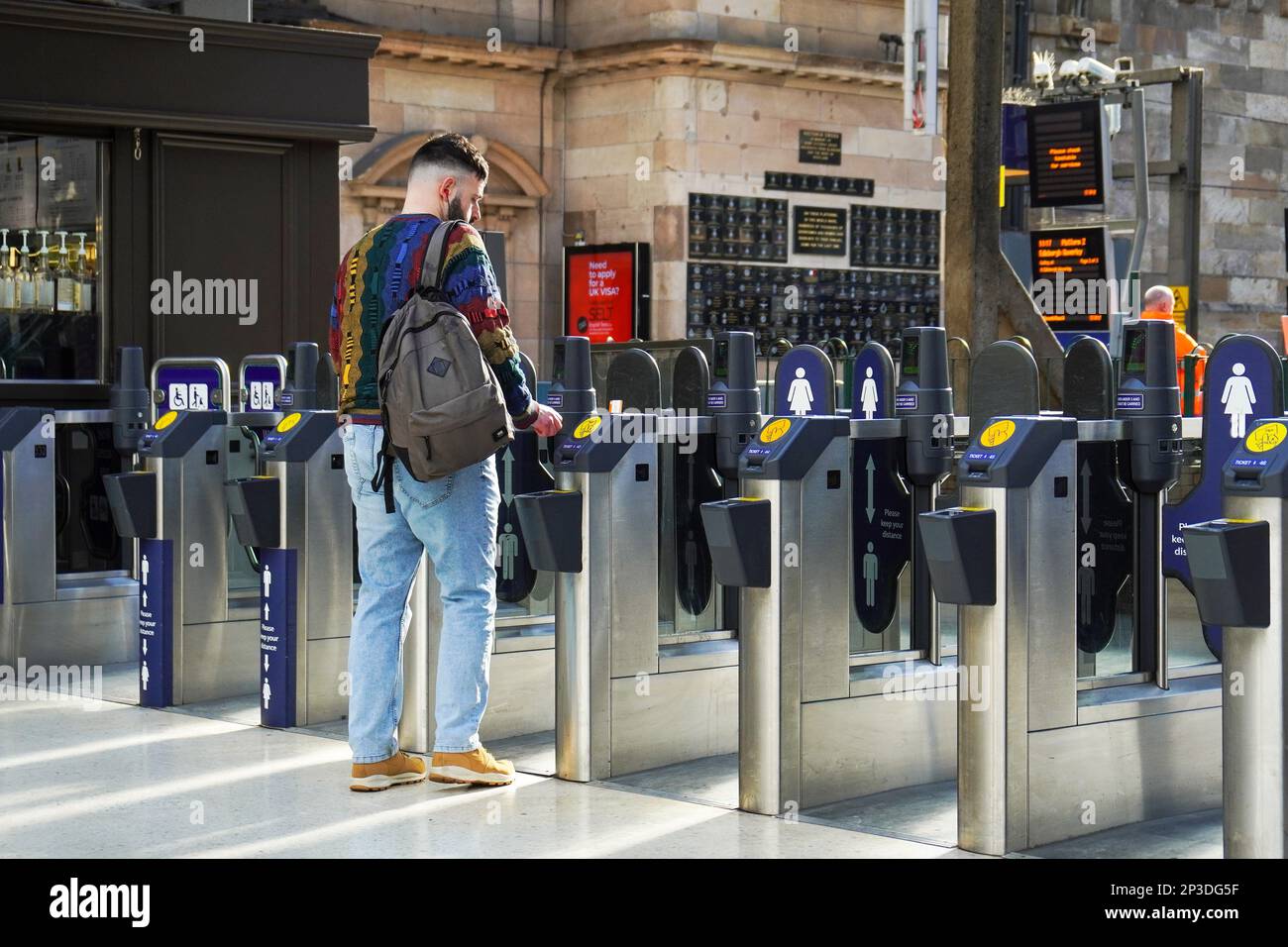 Passenger using the electronic ticket barrier giving access to the ...