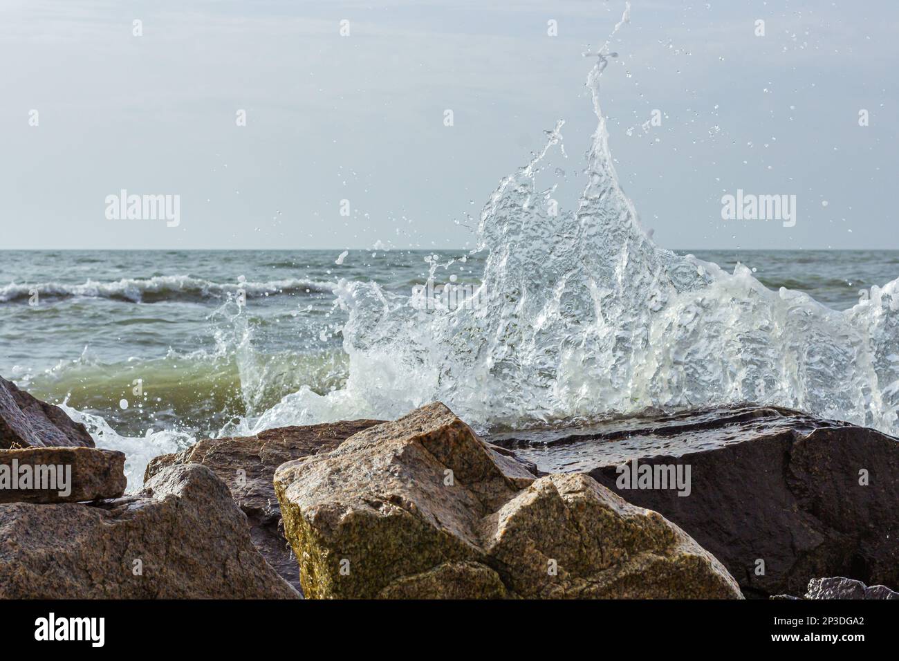 A shot of the sea surf. Splashes of water hitting the stone. Ocean surf ...