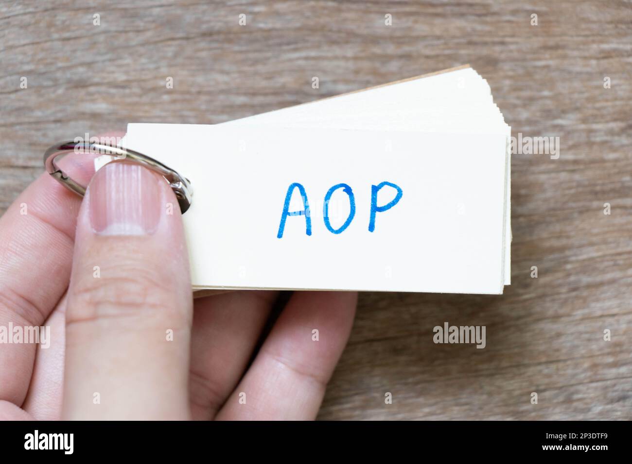 Hand hold flash card with handwriting in word AOP (abbreviation of ...