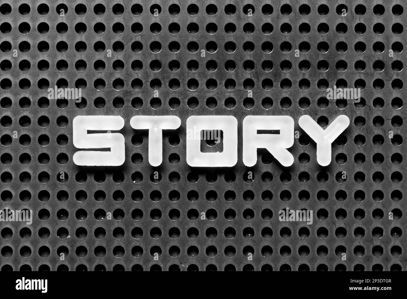 White alphabet letter in word story on black pegboard background Stock ...