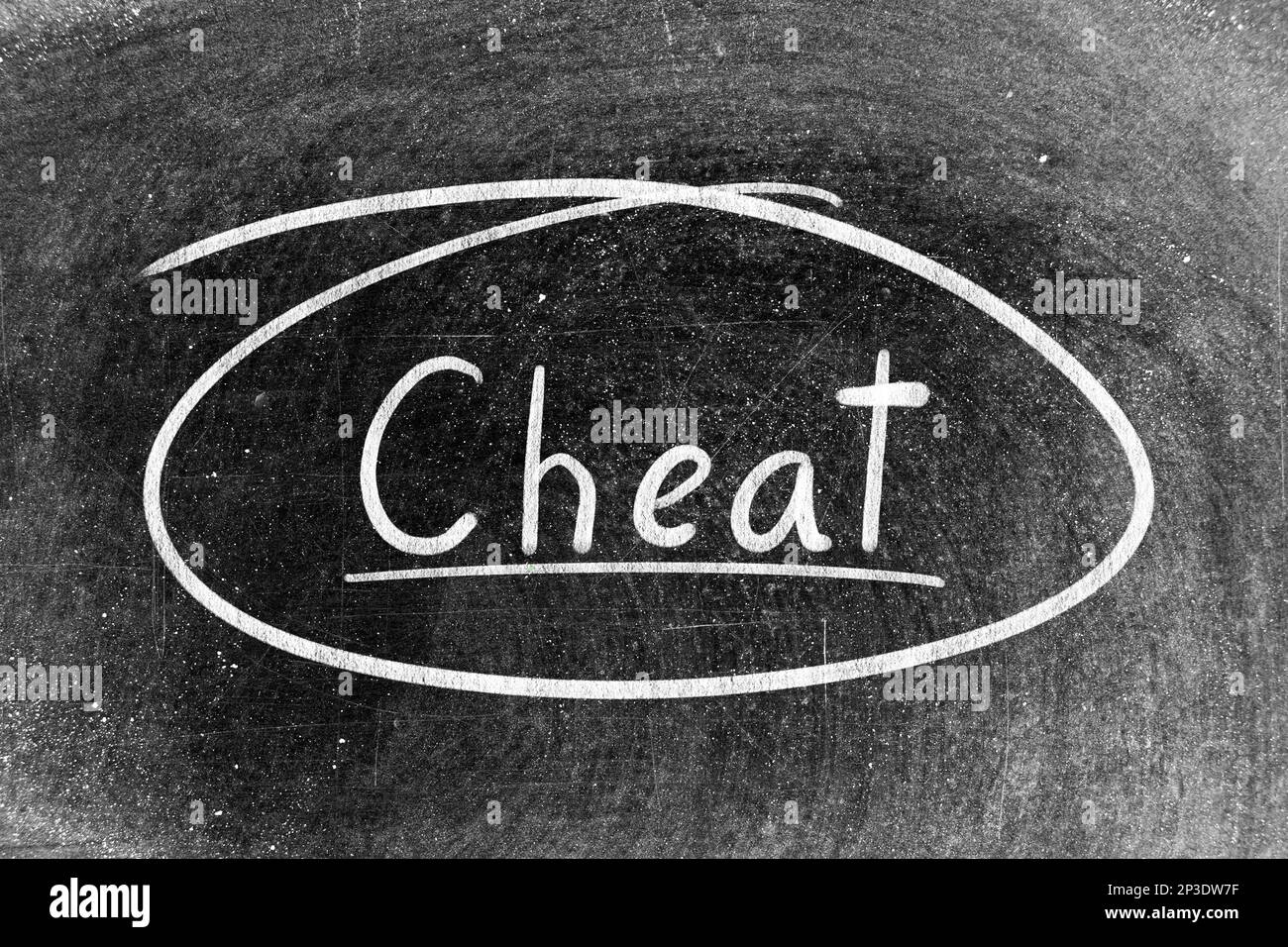 White chalk hand writing in word cheat and circle shape on blackboard ...