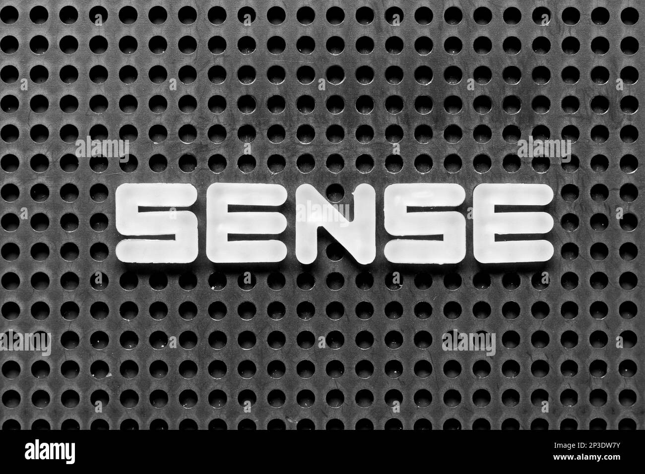 White alphabet letter in word sense on black pegboard background Stock ...