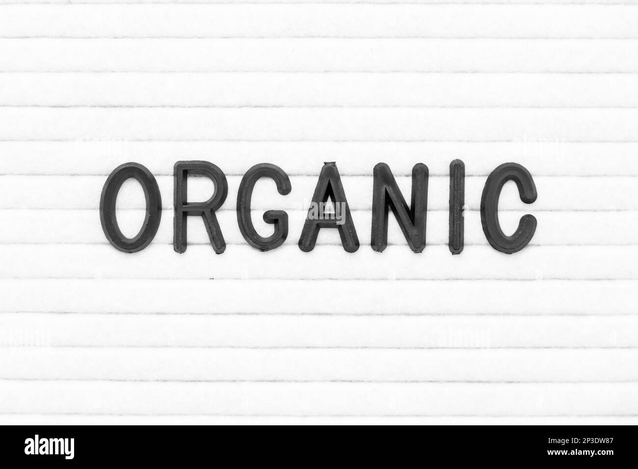 Black color letter in word organic on white felt board background Stock ...