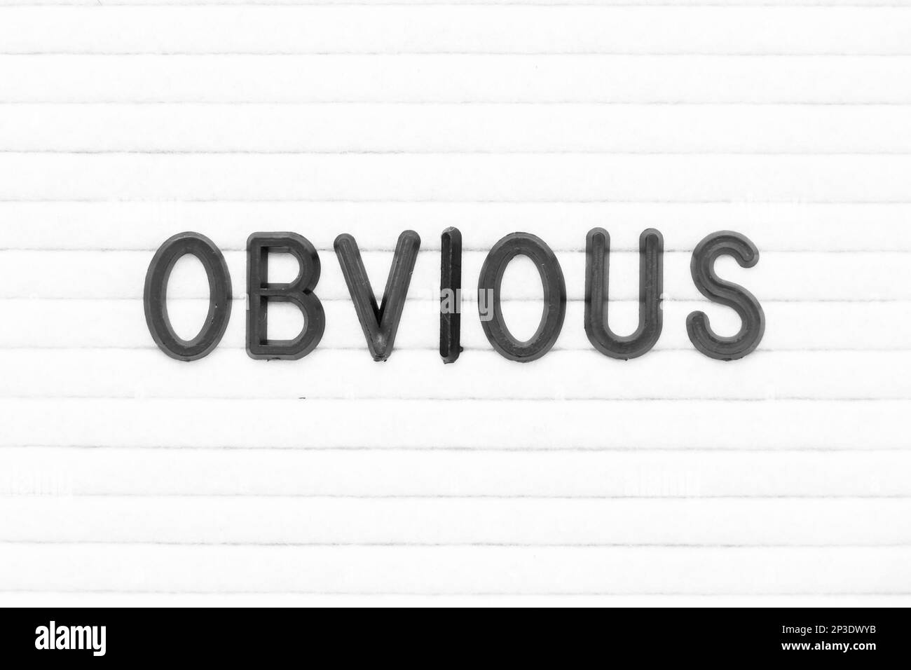 Black color letter in word obvious on white felt board background Stock ...