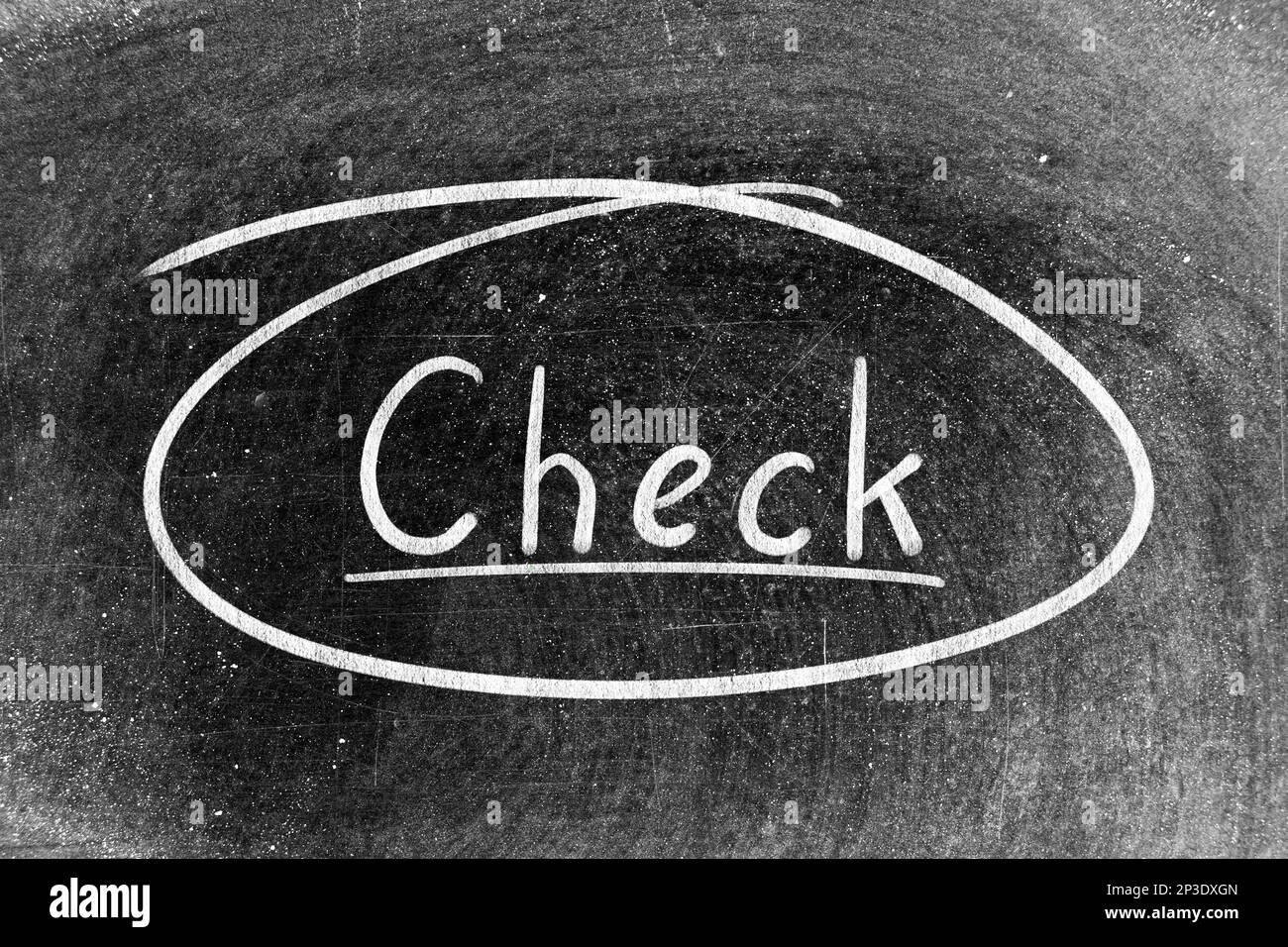 White chalk hand writing in word check and circle shape on blackboard ...