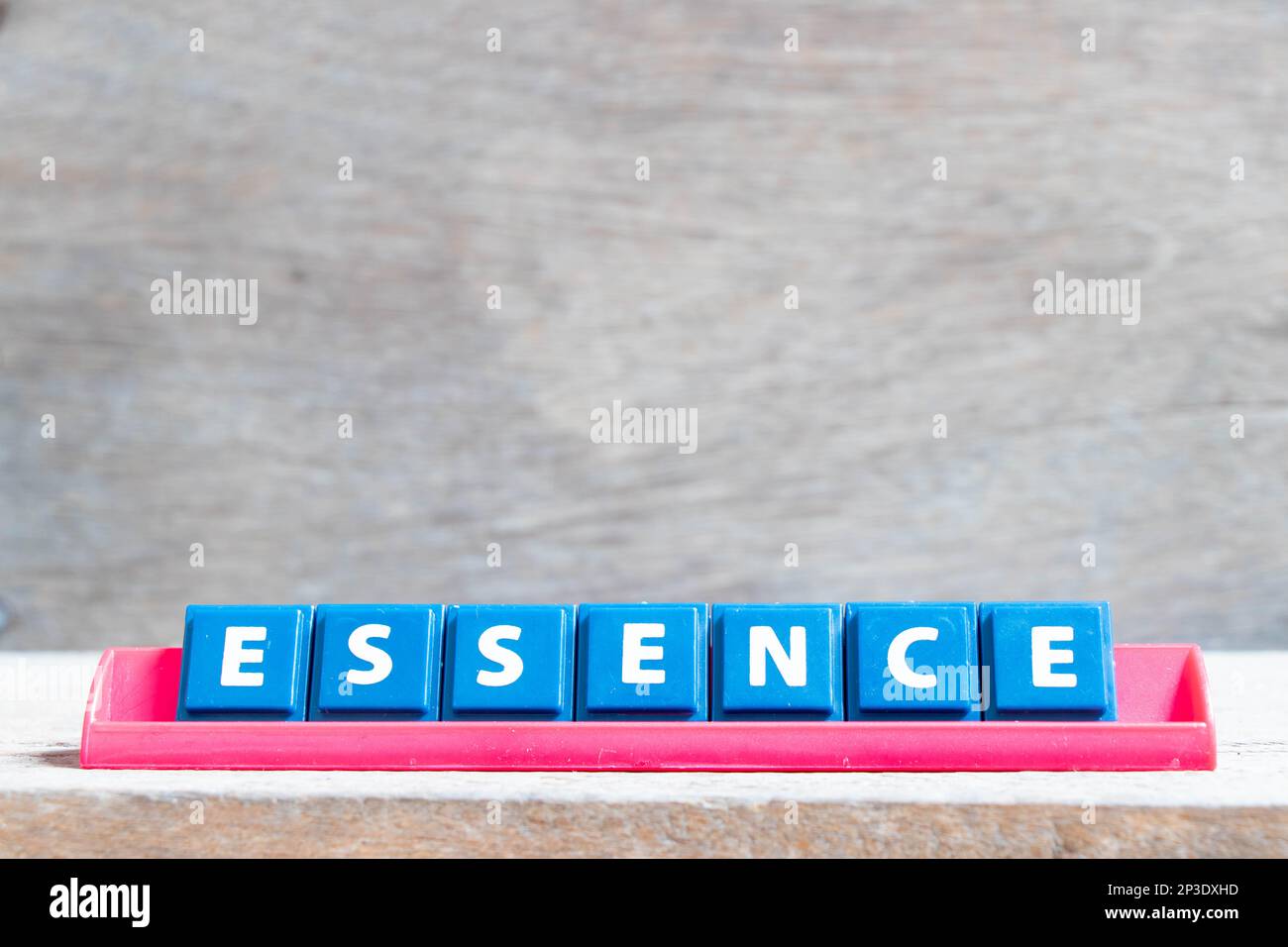 Tile alphabet letter with word essence in red color rack on wood ...