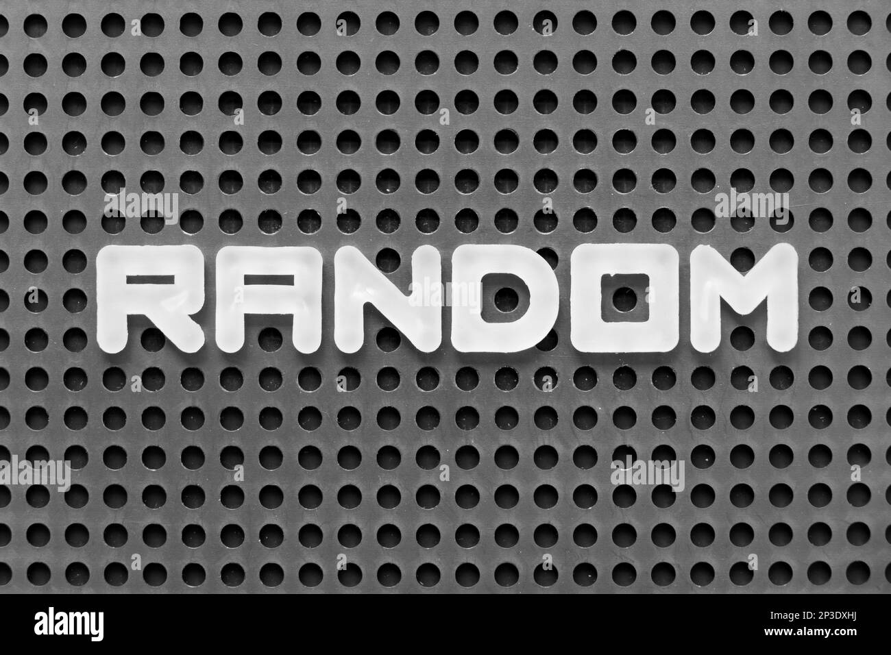 White alphabet letter in word random on black pegboard background Stock ...