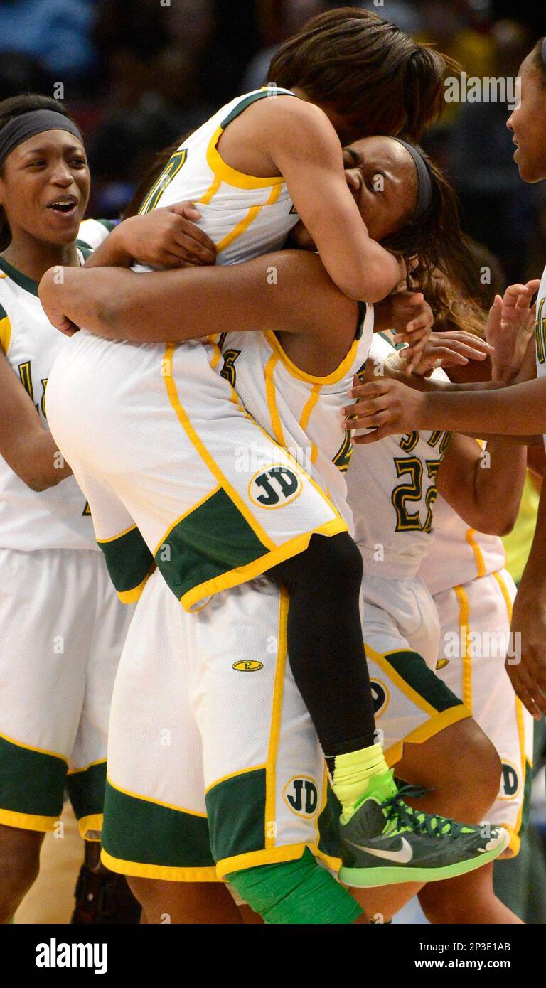 Jeff Davis’ Tia Manora hugs Ahyiona Vason following their 55-54 victory ...