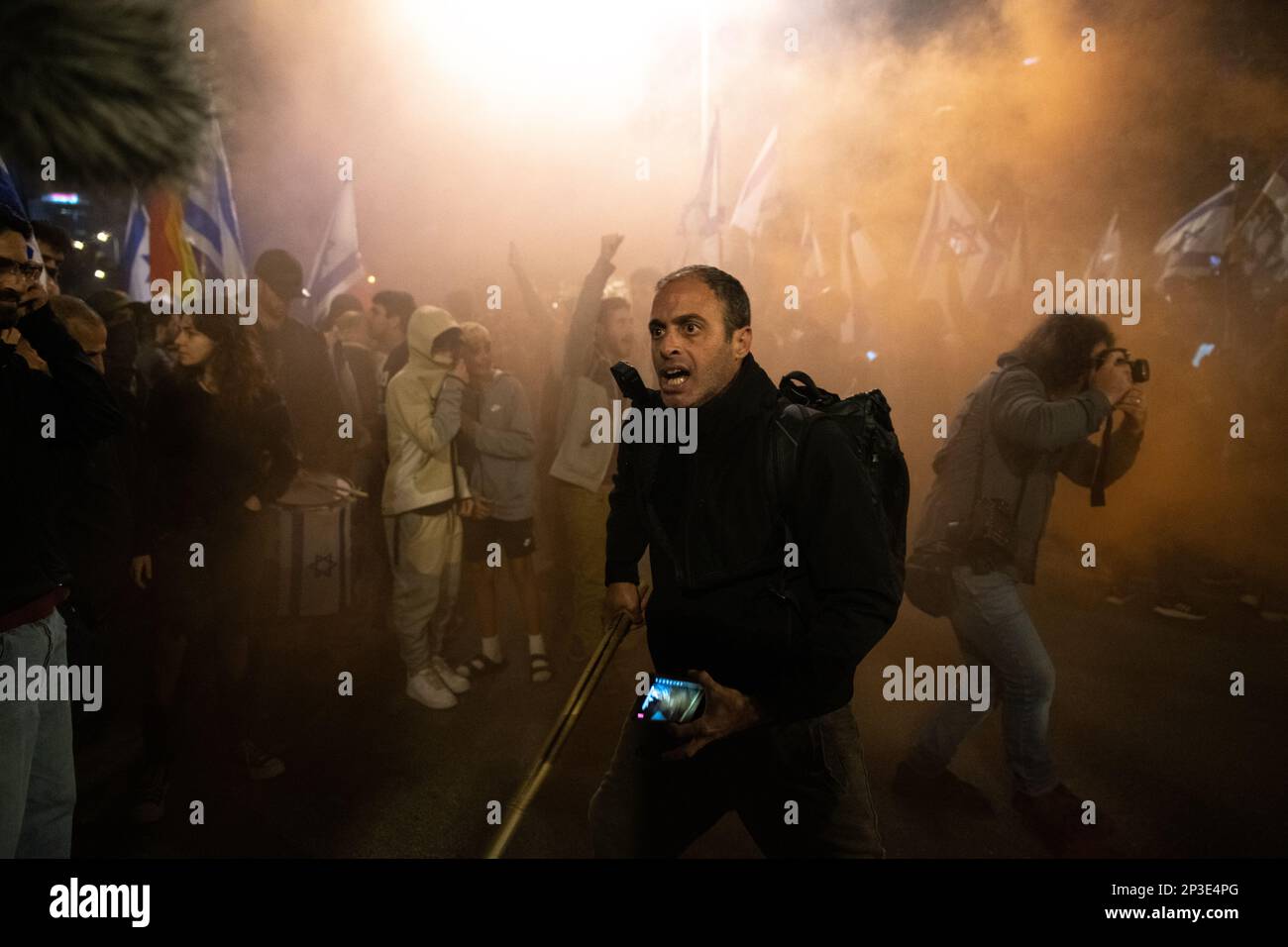 A protestor against the reform is screaming as others chant while ...