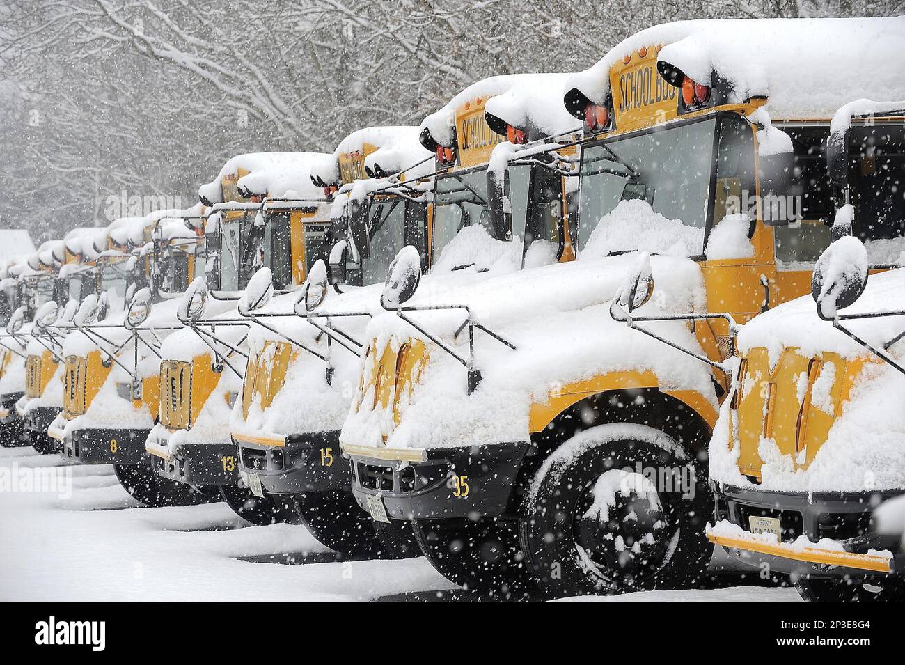 Snow covers school buses after a snowstorm hit the Fredericksburg, Va ...