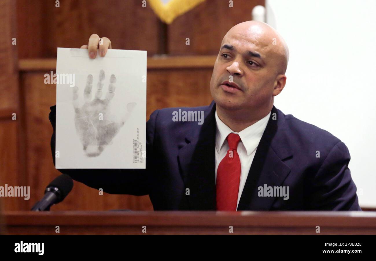 Mass. State Police Trooper Joseph Silva Jr. shows the hand print impression he took of former ...