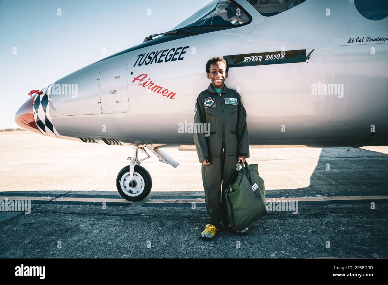 Michael Deigh poses next to his name taped to the side of a T-1 Jayhawk ...