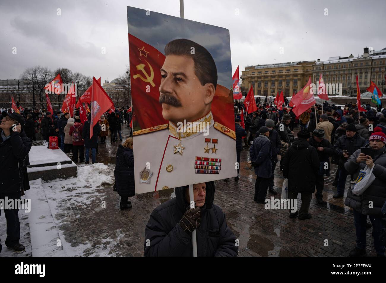 Communist party supporters with red flags and a portrait of Josef ...