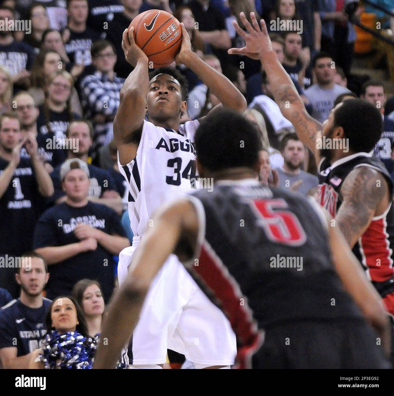 Utah State's Chris Smith lines up a shot over UNLV's Jalen Kendrick and ...