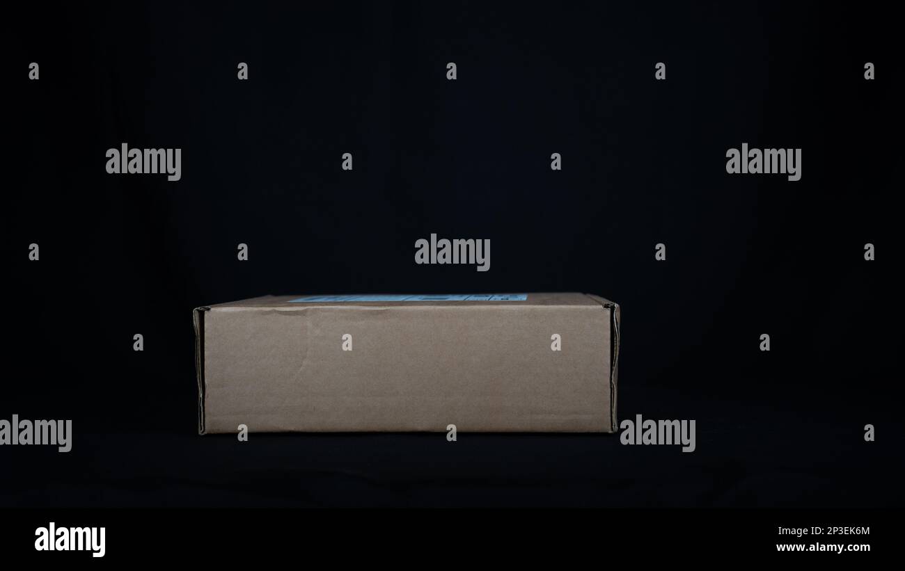 Craft cardboard package box presented vertically on stressed brushed ...