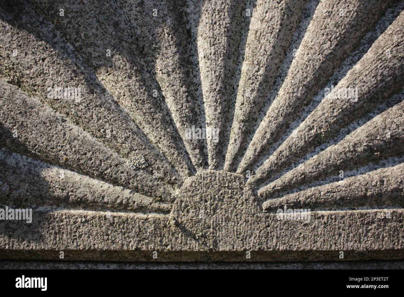 The sunrise motif carved into natural stone Stock Photo - Alamy