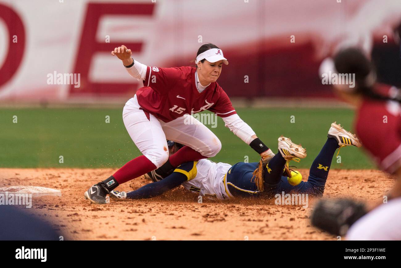 Alabama infielder Danae Hays (15) can't hold on as Michigan's Abby ...