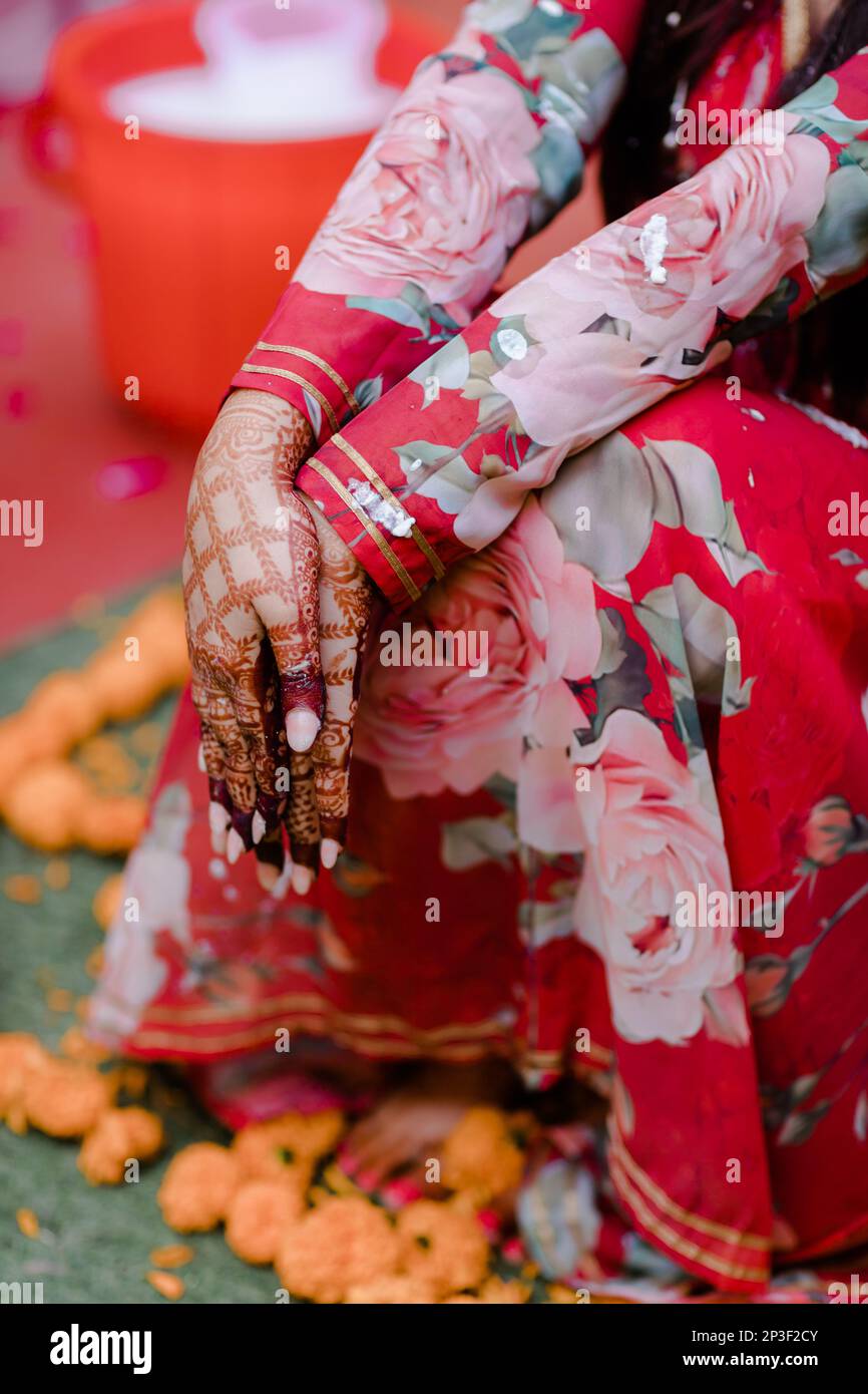 The hands of a newlywed Indian bride with nice henna design, wearing a ...