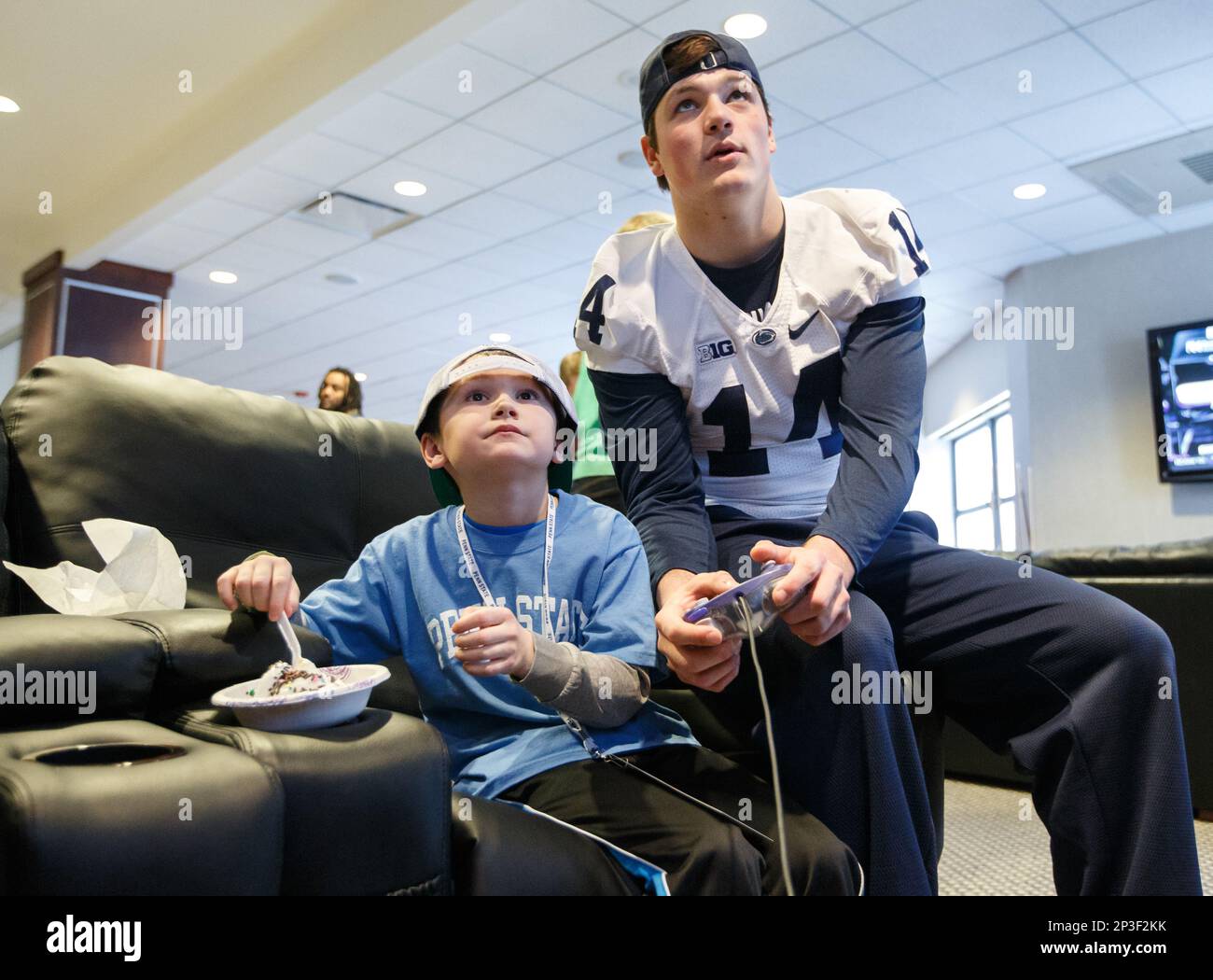 Penn State quarterback Christian Hackenberg plays a video game with Eli ...