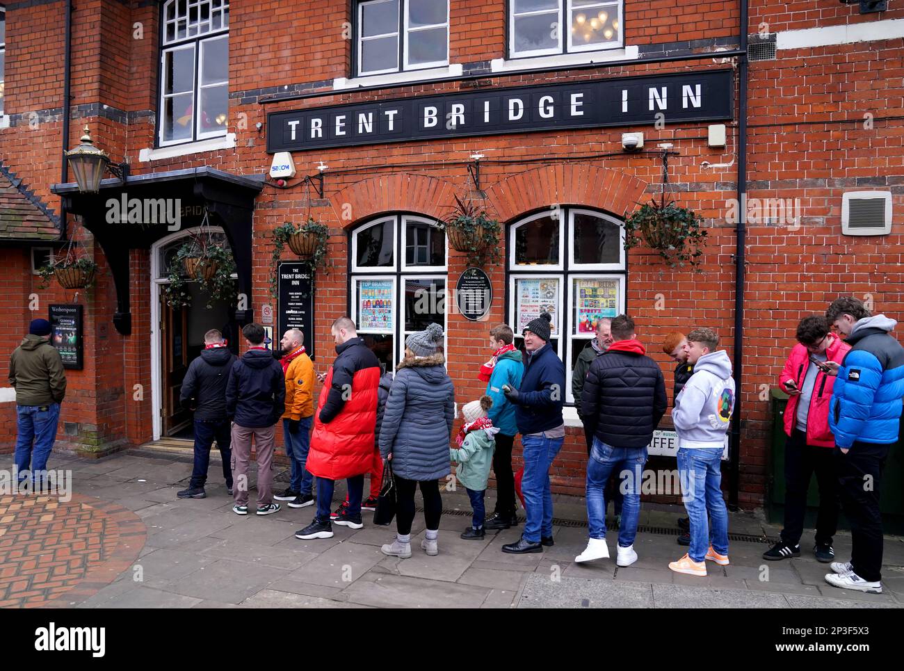 Fans queue outside of the Trent Bridge Inn pub ahead of the Premier ...