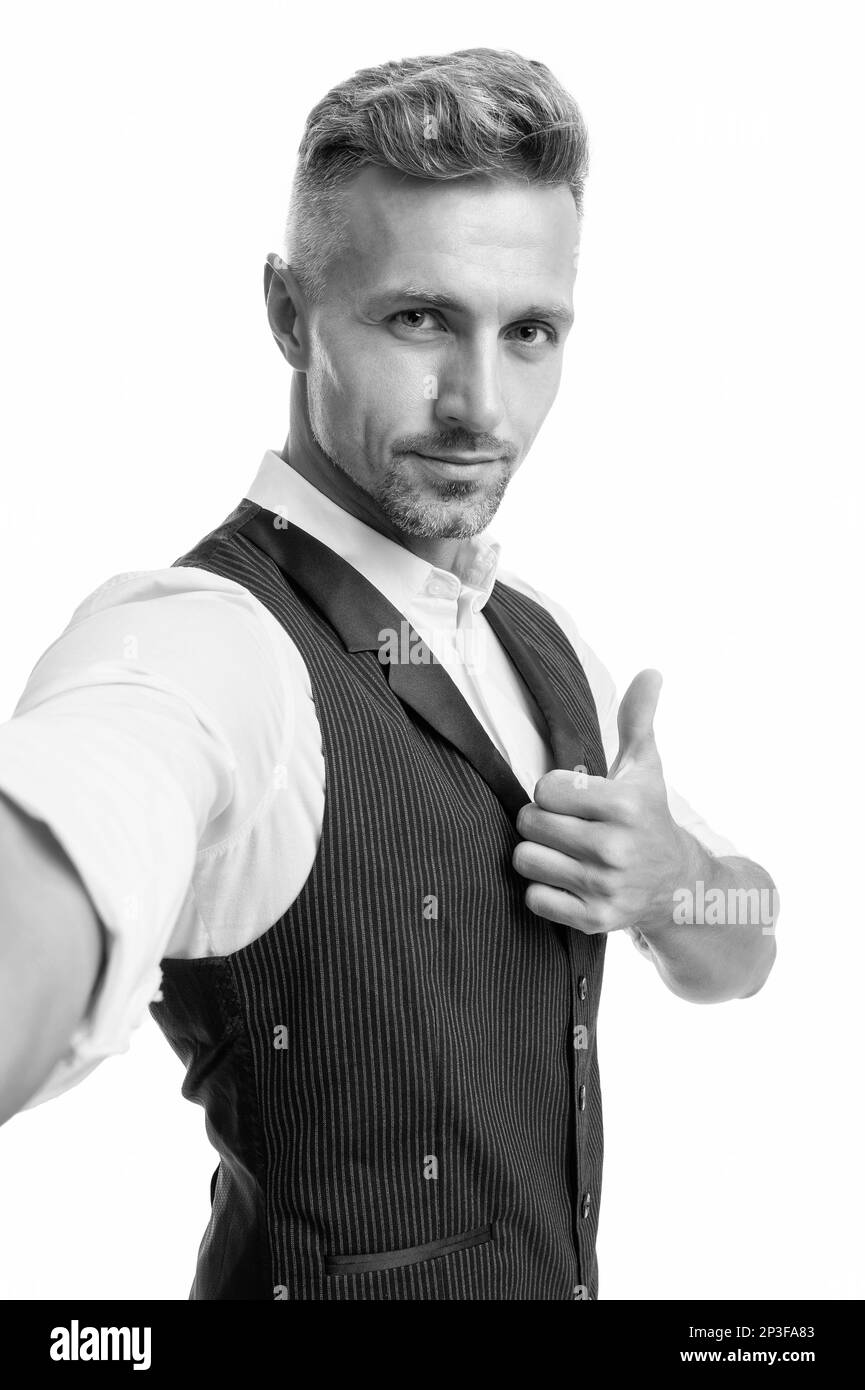 Serious guy in suit vest taking selfie giving thumb gesture isolated on white, thumbs up Stock ...
