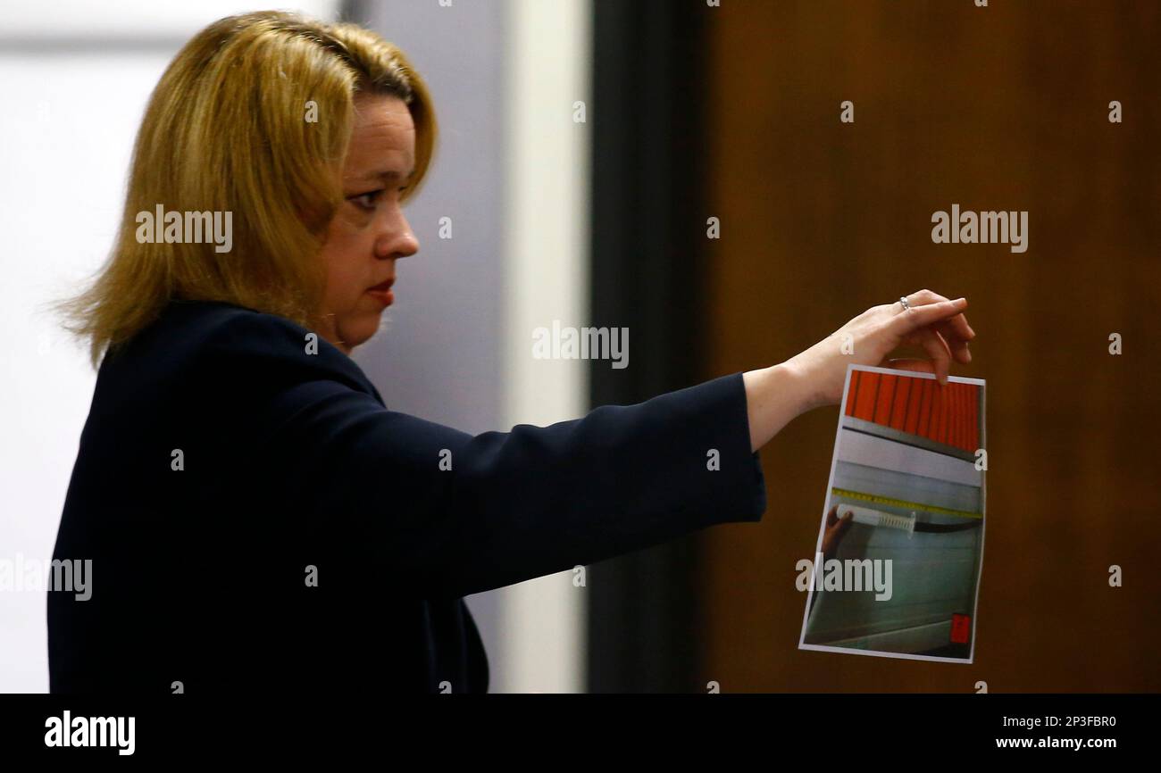 Texas Assistant Attorney Gen. Jane Starnes shows a picture of a sword ...