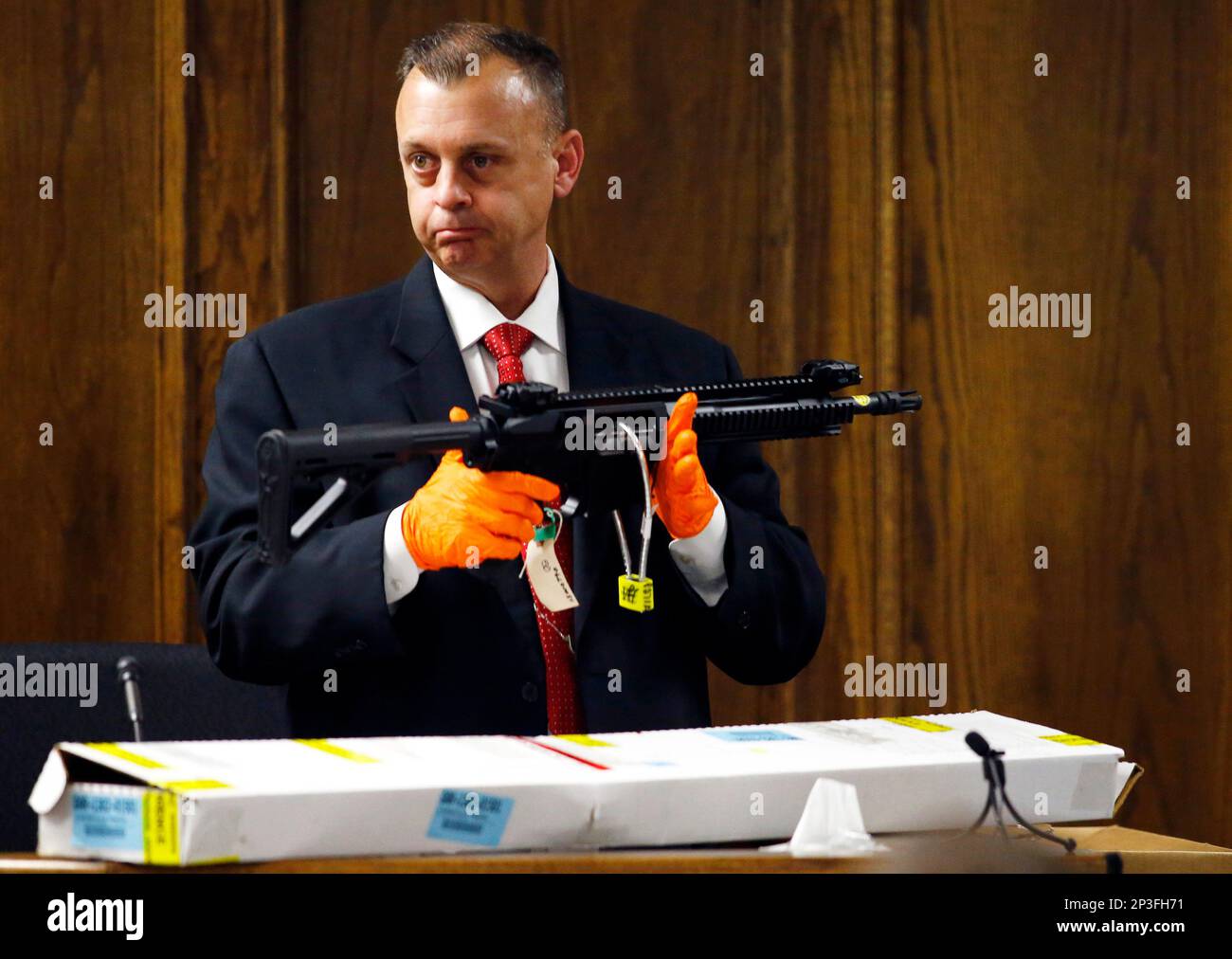 Texas Ranger Michael Adcock holds one of the assault rifles recovered ...