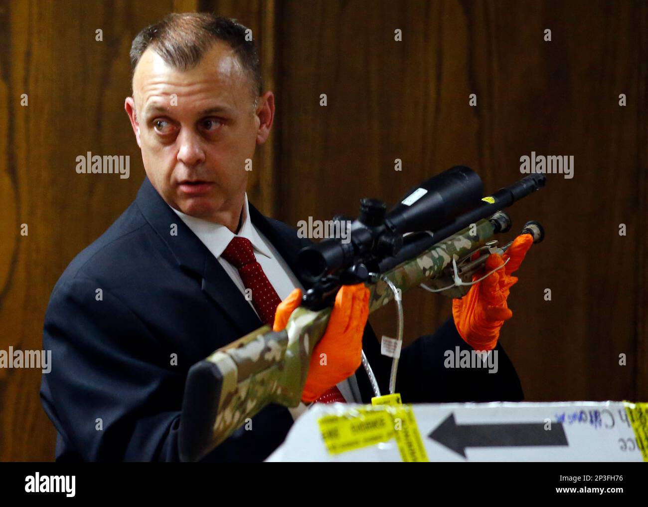 Texas Ranger Michael Adcock holds one of the assault rifles recovered ...