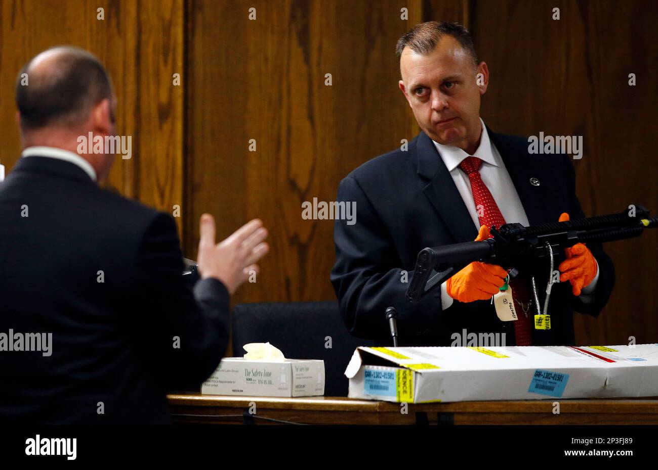 Texas Ranger Michael Adcock holds a .308 caliber rifle with the ...
