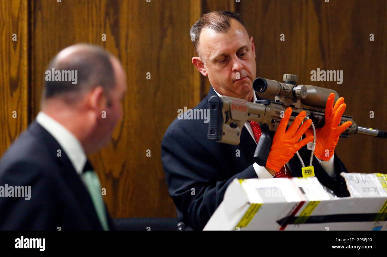Texas Ranger Michael Adcock holds a .308 caliber rifle with the ...