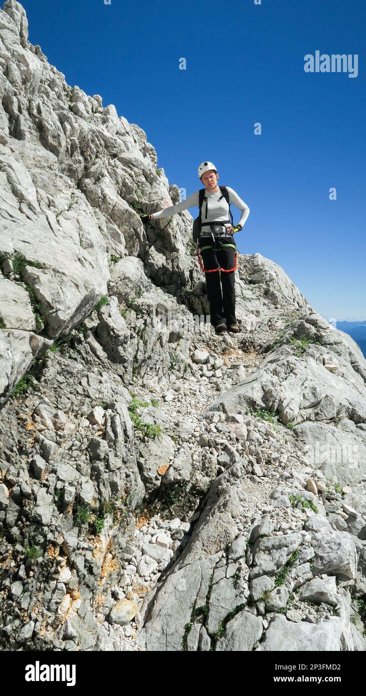 Woman's crossing the via ferrata trail in the alps. Zugspitze massif ...