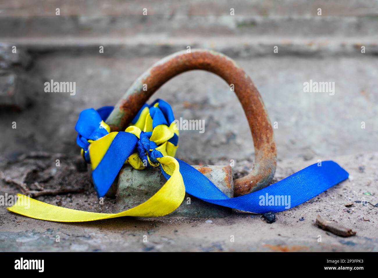 blue-yellow ribbon tied to the weapon. War with Ukraine Stock Photo - Alamy
