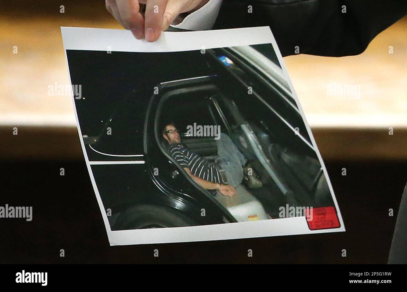 Erath County District Attorney Alan Nash carries a photo of former ...