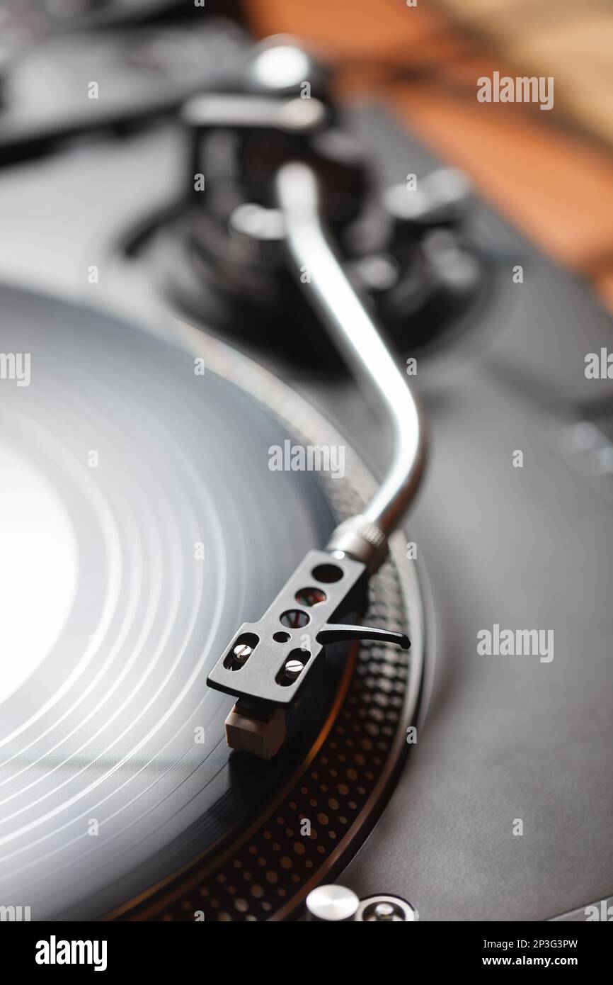 DJ turntable plays hip hop music. Vinyl player tone arm with spherical ...