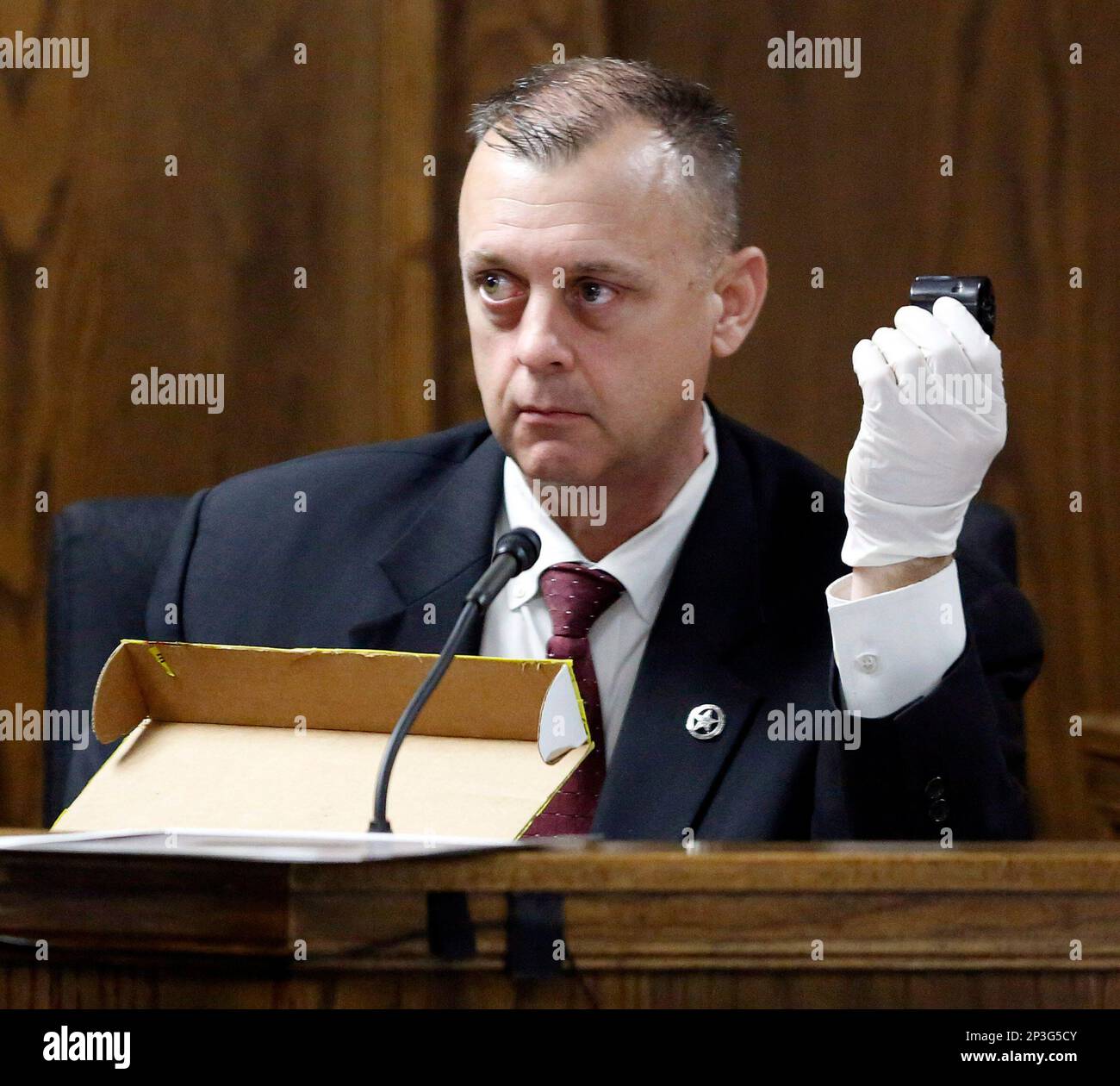 Texas Ranger Michael Adcock shows a revolver cylinder he unpackaged as ...